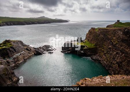 Old quarry buildings top the cliffs above the Blue Lagoon at Abereiddy ...