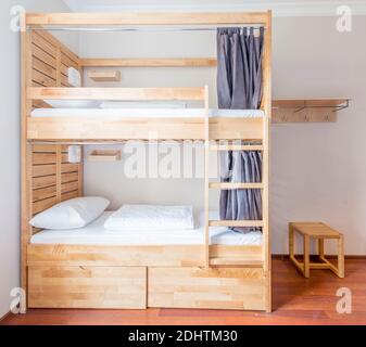 The hostel dormitory beds arranged in room Stock Photo - Alamy