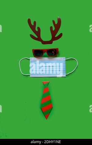 Funny Christmas reindeer horns and decorations on light background ...