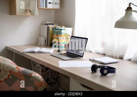 Workplace with laptop, headphones and documents of student of online ...