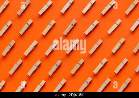 Many wooden clothespin on orange background. Top view Stock Photo - Alamy