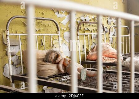 Scary dolls on beds in the kindergarten, a structure for children and a ...