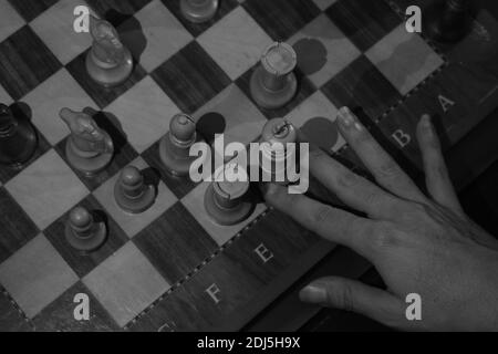 A greyscale shot of chess pieces on a wooden chessboard Stock Photo - Alamy