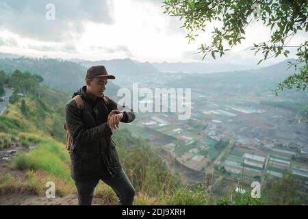 Portrait adventurous man with a backpack captures the moment. Beautiful ...