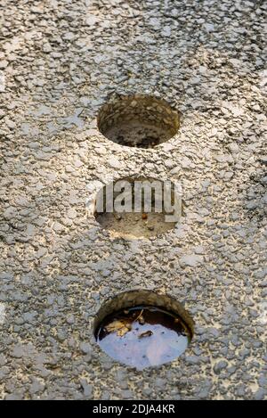 Holes in asphalt pavement, drilled cylindrical specimen for laboratory ...