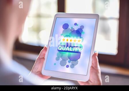 Tablet screen displaying a quality concept Stock Photo - Alamy