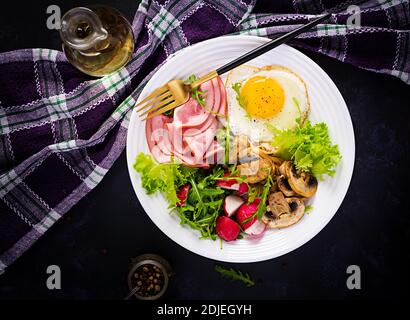 Ketogenic food. Fried eggs, mushrooms and sliced tomatoes. Keto, paleo ...