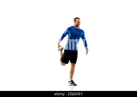 Prepares. Caucasian professional jogger, runner training isolated on ...
