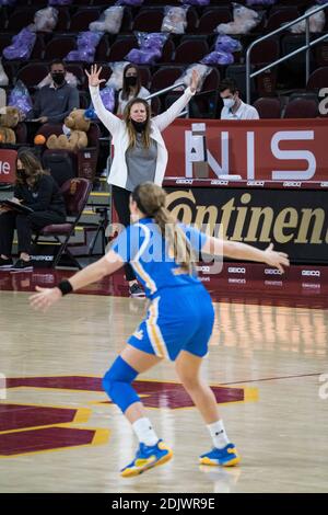 UCLA head coach Cori Close runs onto the court before an NCAA college ...