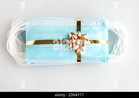 Hygienic face masks as a gift with a golden ribbon, top view ...