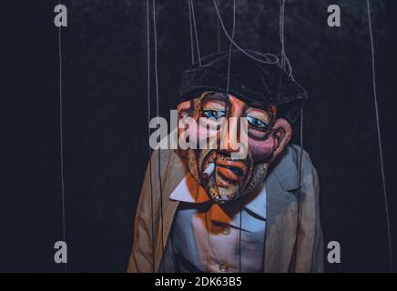 A closeup of a hand made realistic puppets on a black background Stock ...