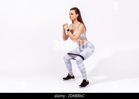 Strong woman bodybuilder stretching on wall background Stock Photo - Alamy