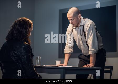 A young detective interviews a suspect in a crime Stock Photo - Alamy