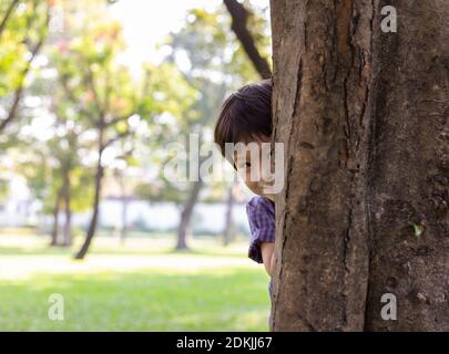 Little child is hiding something behind her back Stock Photo - Alamy