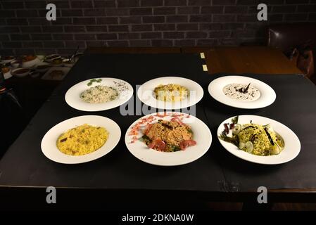 five rice dishes of different flavours served in one table with spicy ...