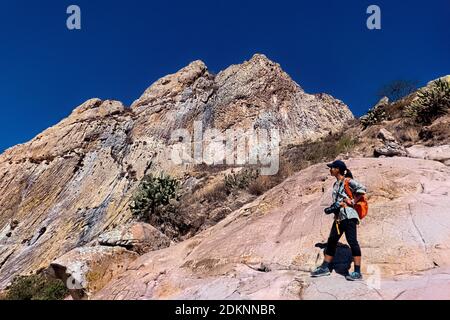 Standing under Peña de Bernal, UNESCO site and one of the world’s ...