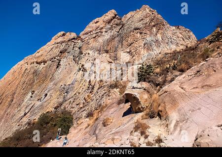 Standing under Peña de Bernal, UNESCO site and one of the world’s ...