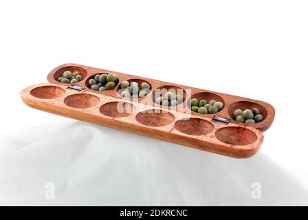 Traditional African oware game with seeds isolated on white background ...