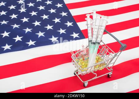 Hypodermic syringes & glass ampules on Stars and Stripes. For US covid ...