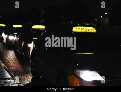 Taxi signs in English and Arabic in the Arabian Gulf Stock Photo - Alamy
