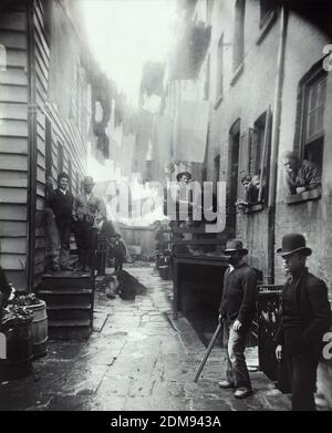 Bandit's Roost photo by Jacob Riis. It depicts a group of men on the ...