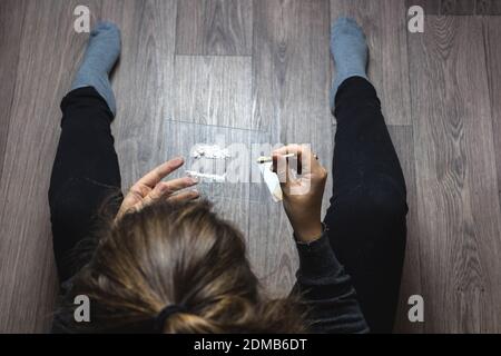 A young woman snorting a line of cocaine off a mirror through a Stock ...