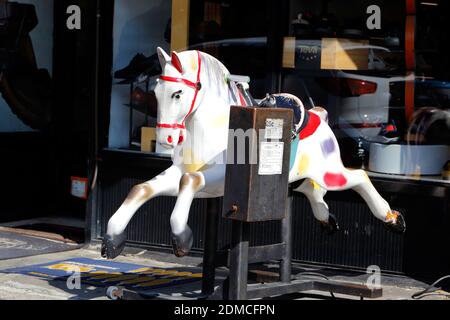 A coin-operated kiddie ride vending machine, a horse amusement ride ...