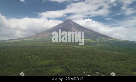 Aerial view of Mayon volcano eruption at green valley. Rural fields at ...