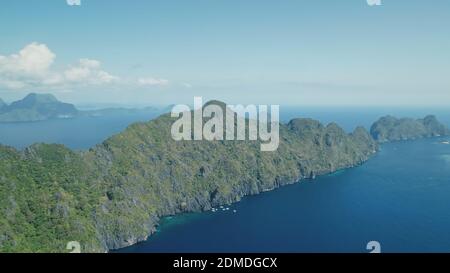 Aerial view, archipelago with grass, turquoise sea, steep mountains in ...