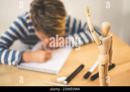 Student drawing with pencil a human figure be inspired by a wooden ...