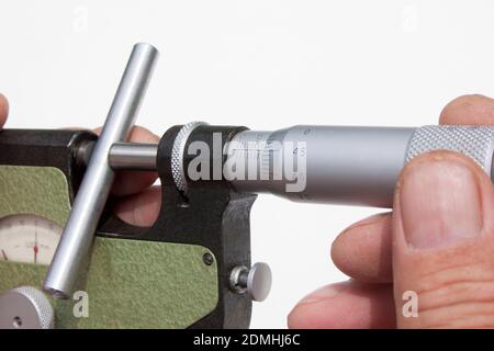 Shaft diameter measurement with a micrometer. Men's hands measure the ...