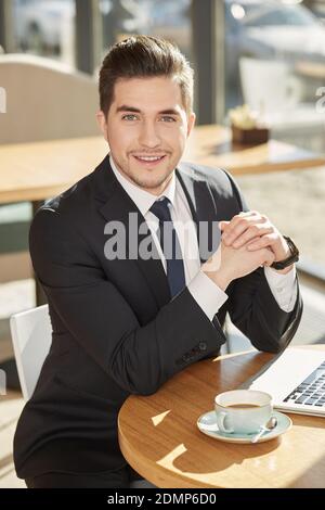 Young handsome businessman relaxing at the coffee shop Stock Photo - Alamy