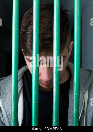 Single male prisoner behind bars in jail cell, USA Stock Photo - Alamy