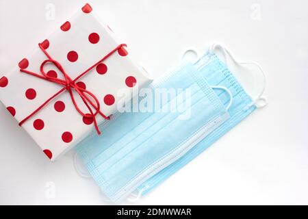 Disposable face masks and gift box on white background with copy space ...