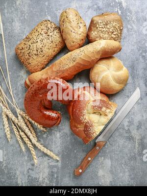 Assorted buns on grey stone background. Breakfast time Stock Photo - Alamy