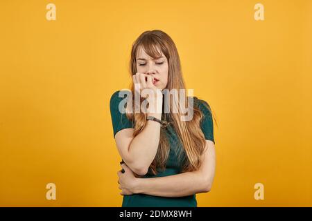 Scared, biting fists emotionally. Covering mouth behind knuckle. Having ...