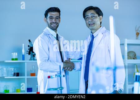 Two scientists shaking hands positivity success happiness. Concept ...