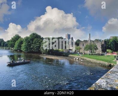 Anglers fishing from the Bridge Pool punt beside Christchurch Castle ...