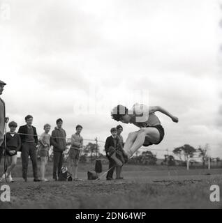 Man doing long jump Stock Photo - Alamy