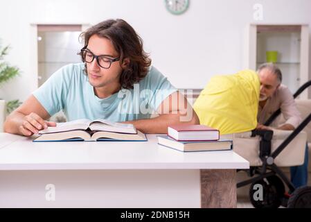 Old grandfather looking after newborn at home Stock Photo - Alamy