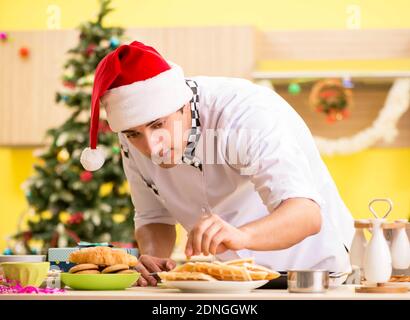 Young chef husband working in kitchen at Christmas eve Stock Photo - Alamy