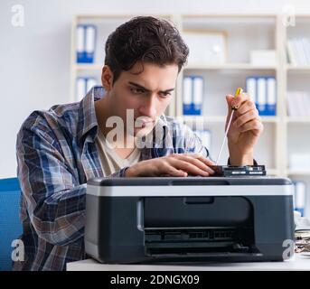 Hardware repairman repairing broken printer fax machine Stock Photo - Alamy
