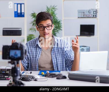 Vlogger recording computer repair on camera for vlog blog Stock Photo ...