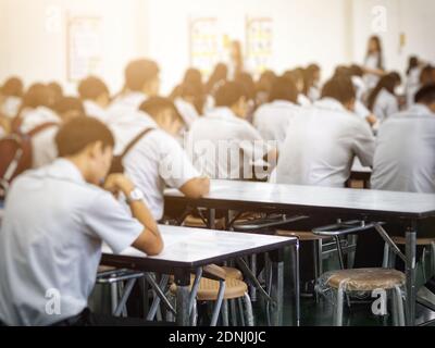 Students on bench in classroom Stock Photo - Alamy