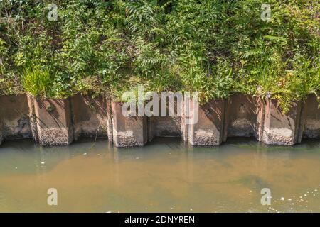 Metal barrier to reduce bank side water erosion. Concept river ...