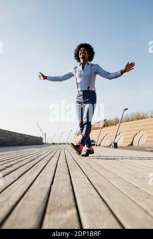 Man dancing on boardwalk Stock Photo - Alamy