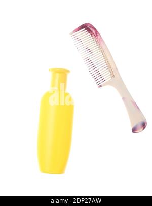 Top view of an unlabeled cosmetic bottle placed next to a plate of sea ...
