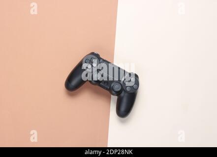 Gamepads on a colored paper background. Top view. Minimalism. Hard ...