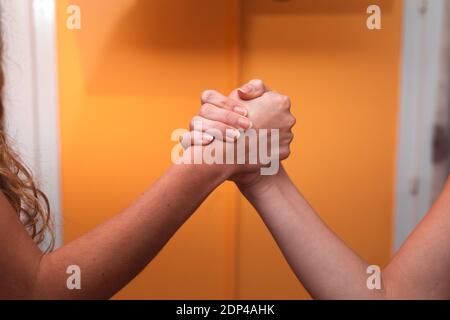 Two women greeting clashing their hands Stock Photo - Alamy