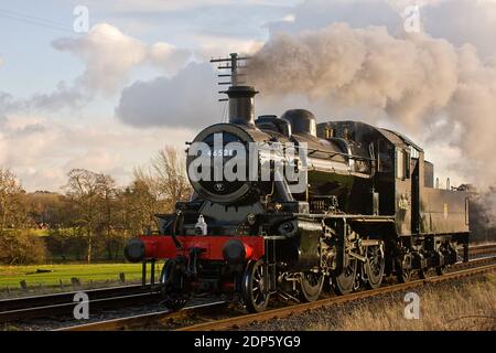 LMS Ivatt Class 2 2-6-0 No. 46521 catches the sun as it powers south ...